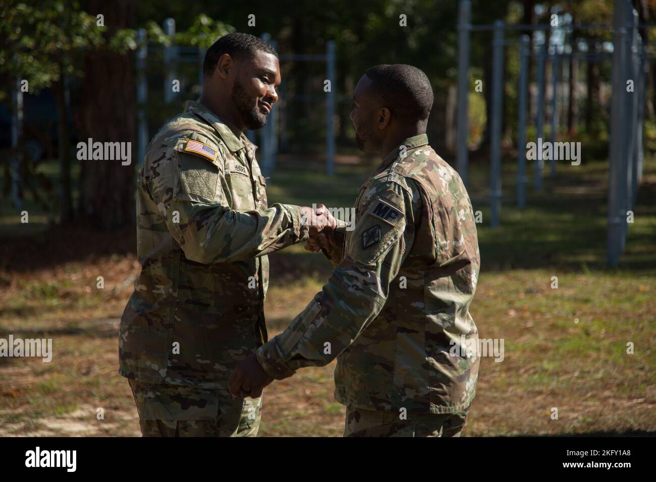 U.S. Army Sgt. Nathaniel Hendrix, left, shakes hands with Staff Sgt ...