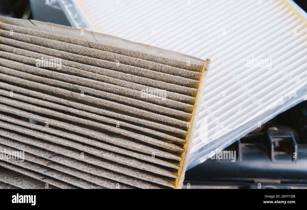 Car air filter clogged and new air filter in a plastic wrapped on ...