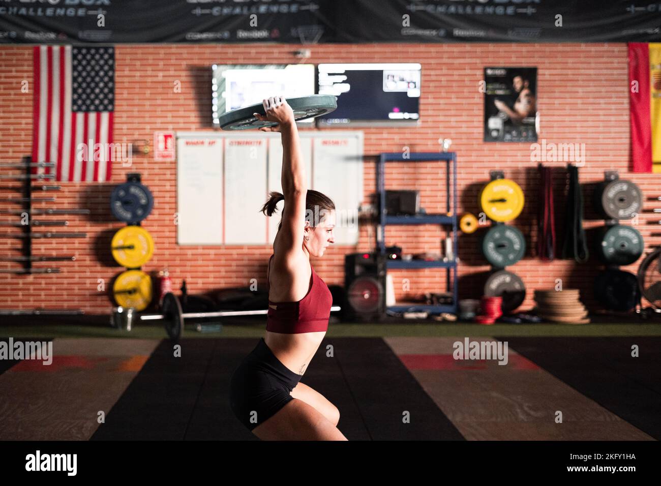 caucasian girl doing sports crouching with her arms outstretched with a ...