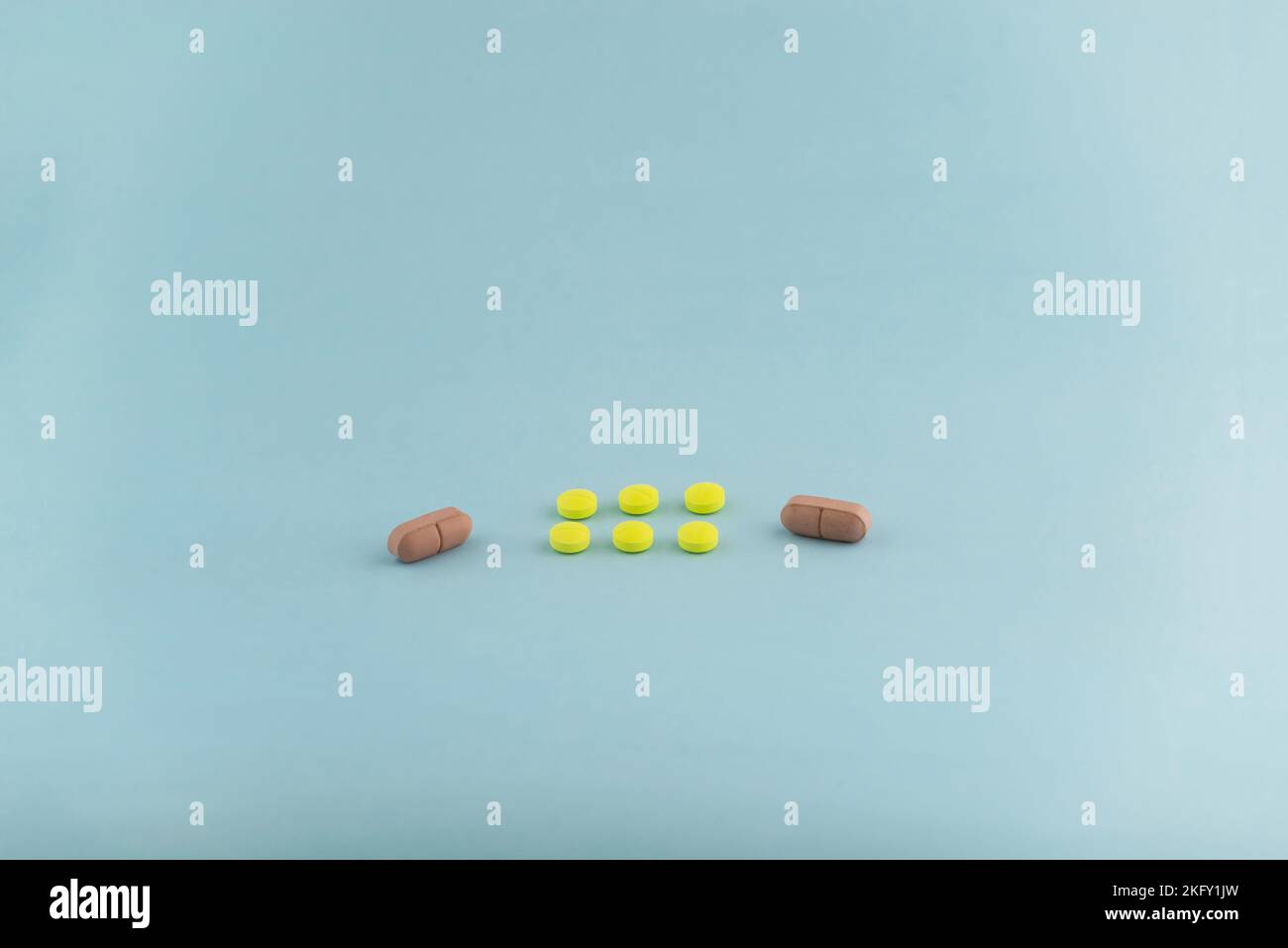 A simple pile of colorful pills stacked on blue background Stock Photo ...