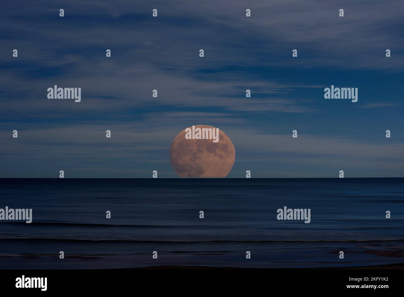 Photo of the moon rising over the sea. Illustration. calm water with ...