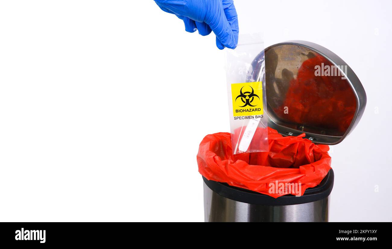 Infectious garbage is being thrown into the red infectious waste bin by ...