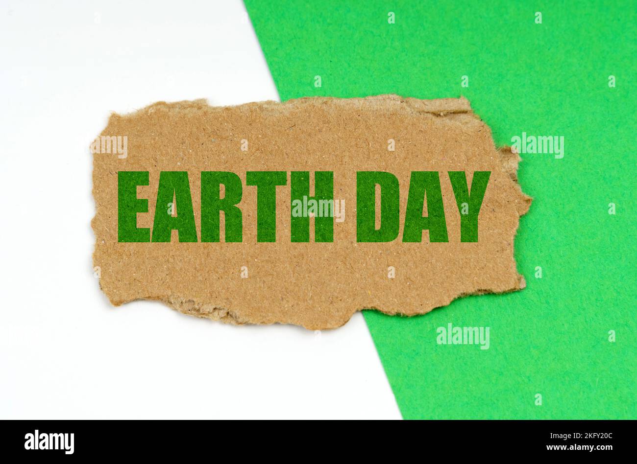 Environmental concept. On a white-green background lies a piece of ...