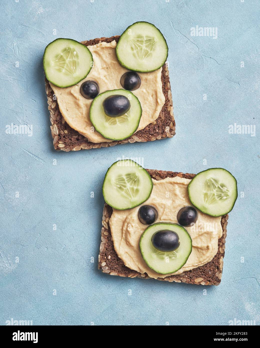 Funny bear toast with cucumber and hummus toasts Stock Photo - Alamy