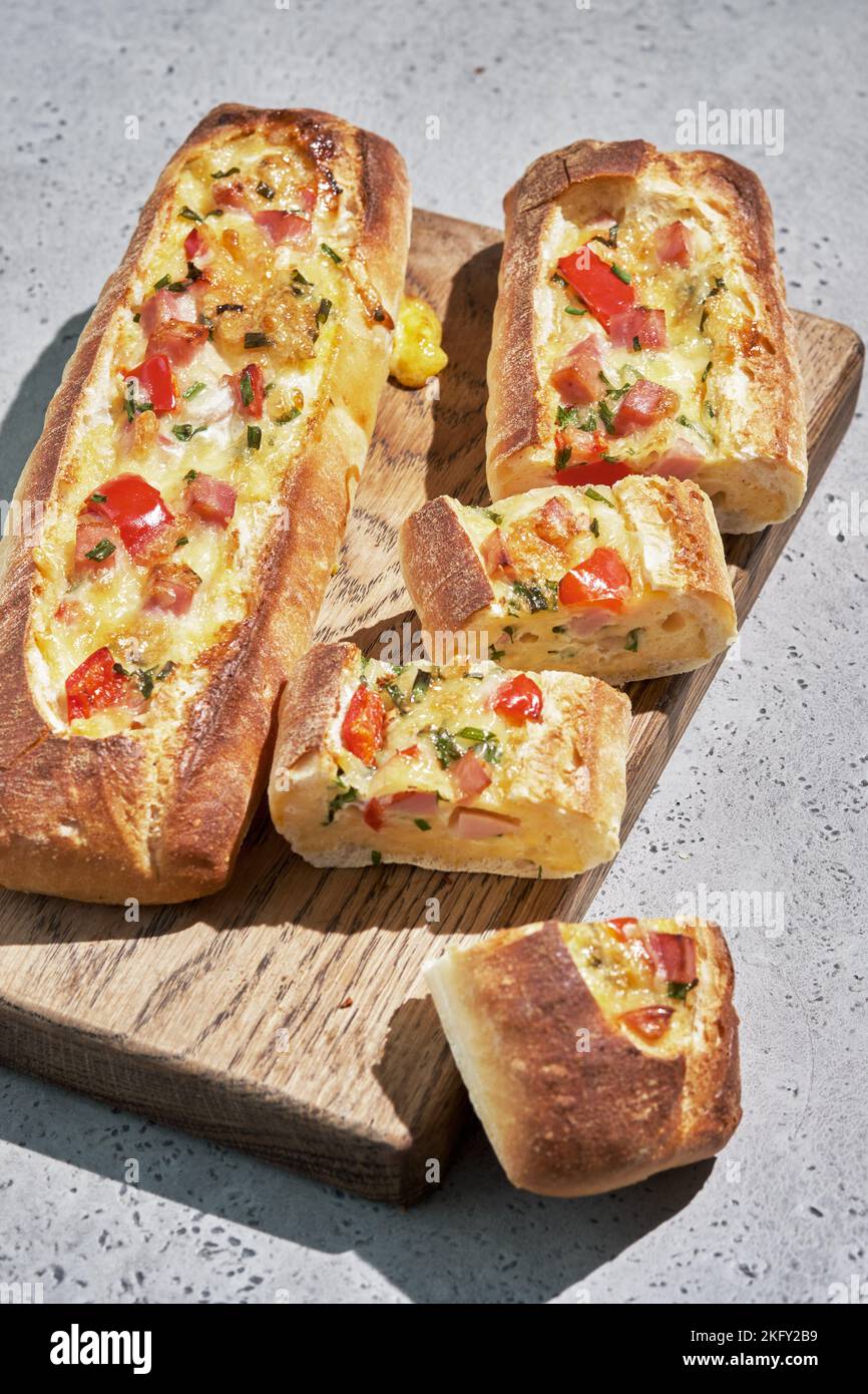 Bread boats stuffed with ham, egg, green onion and cheese for breakfast ...