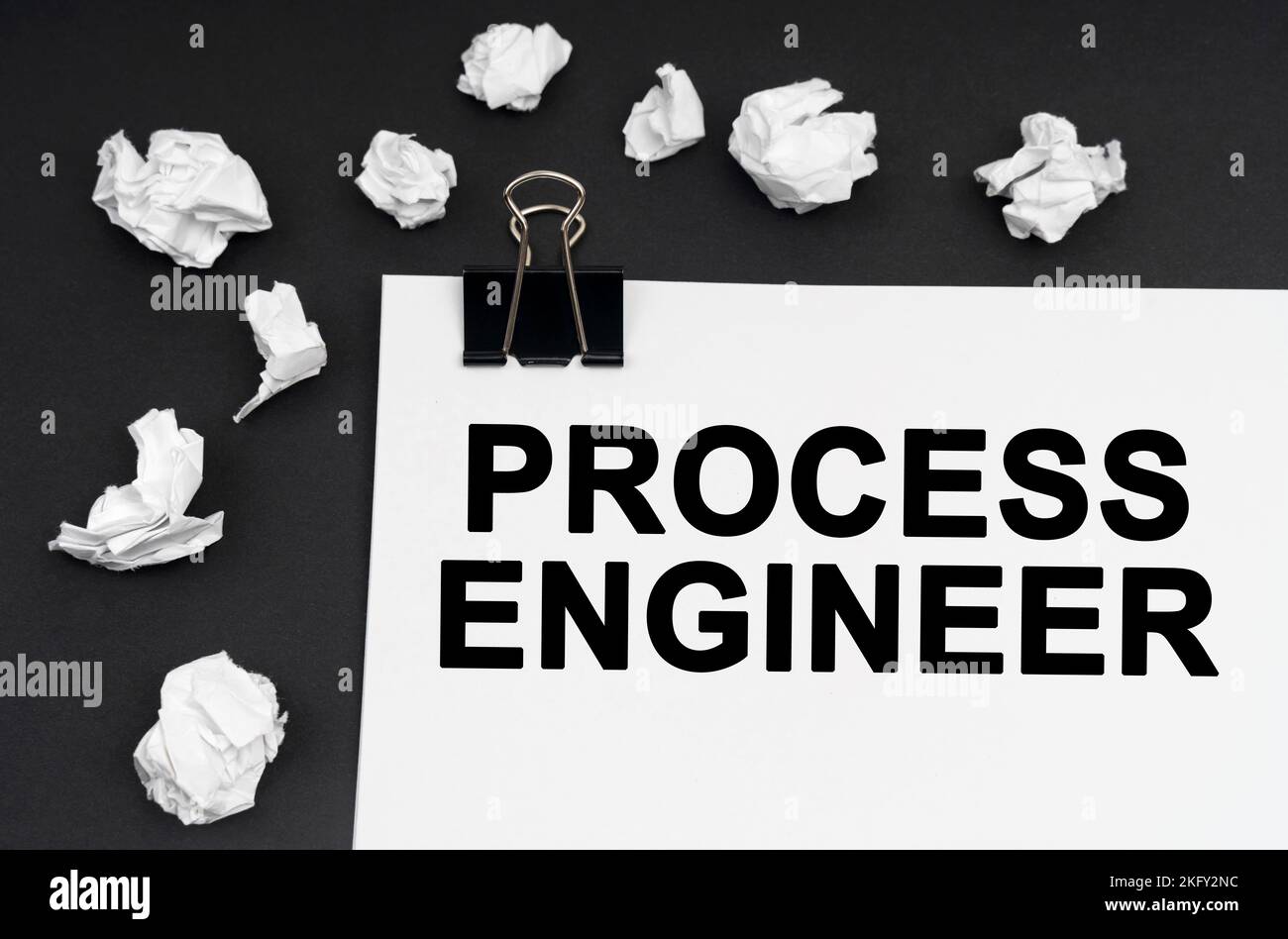 Industrial concept. On a black background, there are crumpled pieces of ...