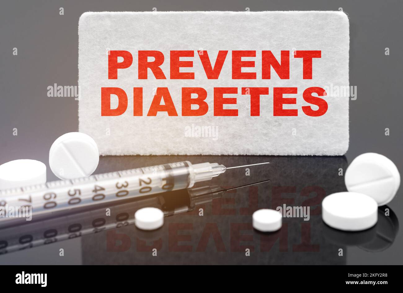 Medicine and health concept. On a black reflective surface, pills, a ...