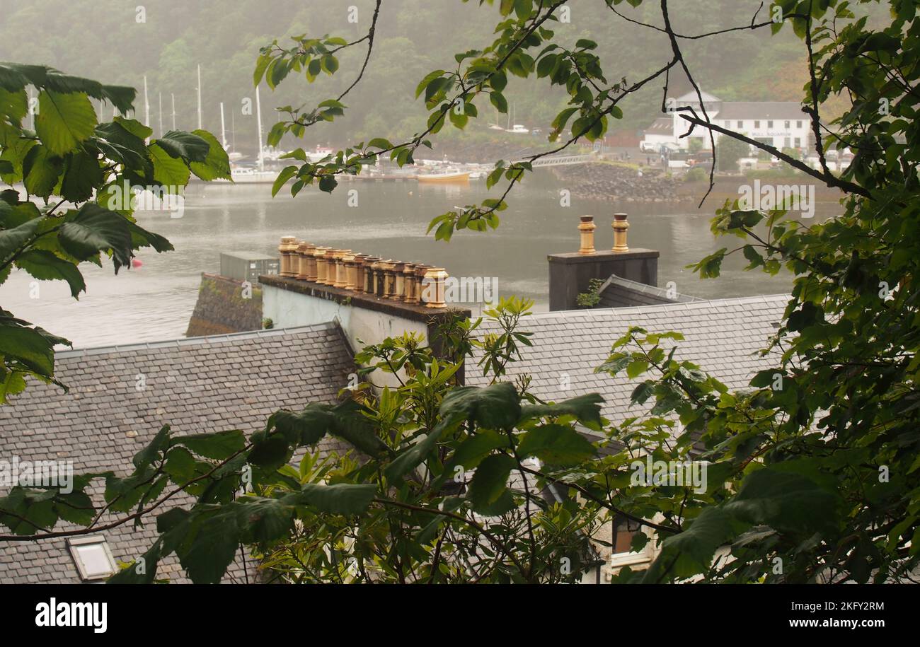 A view looking down onto rooftops and chimney stacks at Tobermory, Mull ...