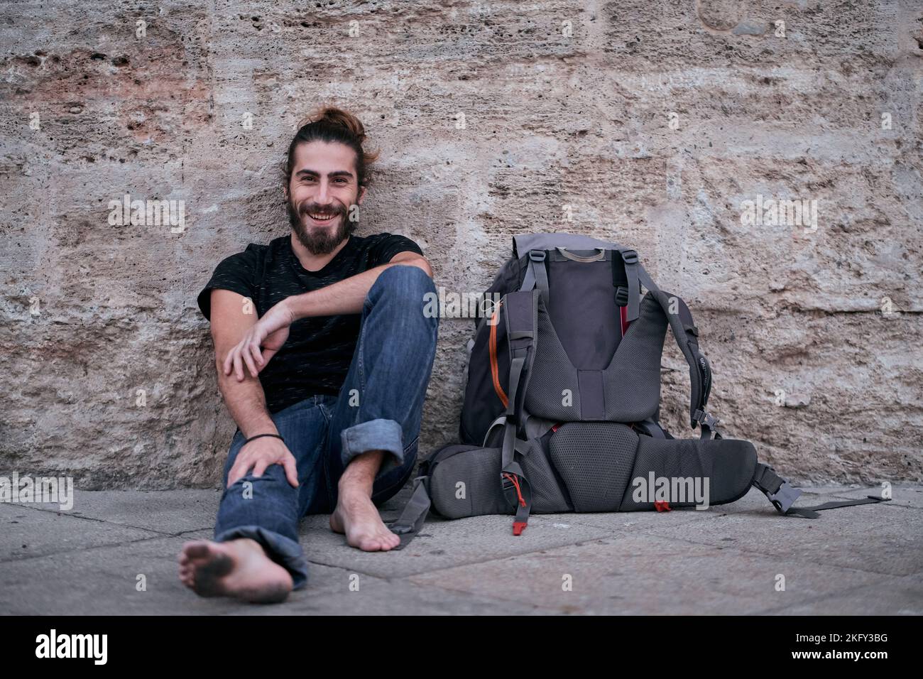 caucasian guy with beard long hair barefoot happy and content sitting ...