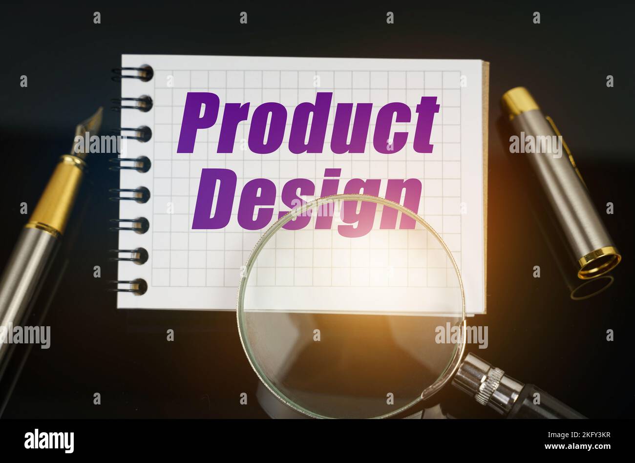 Business and Economics. On the black surface is a pen, a magnifying ...