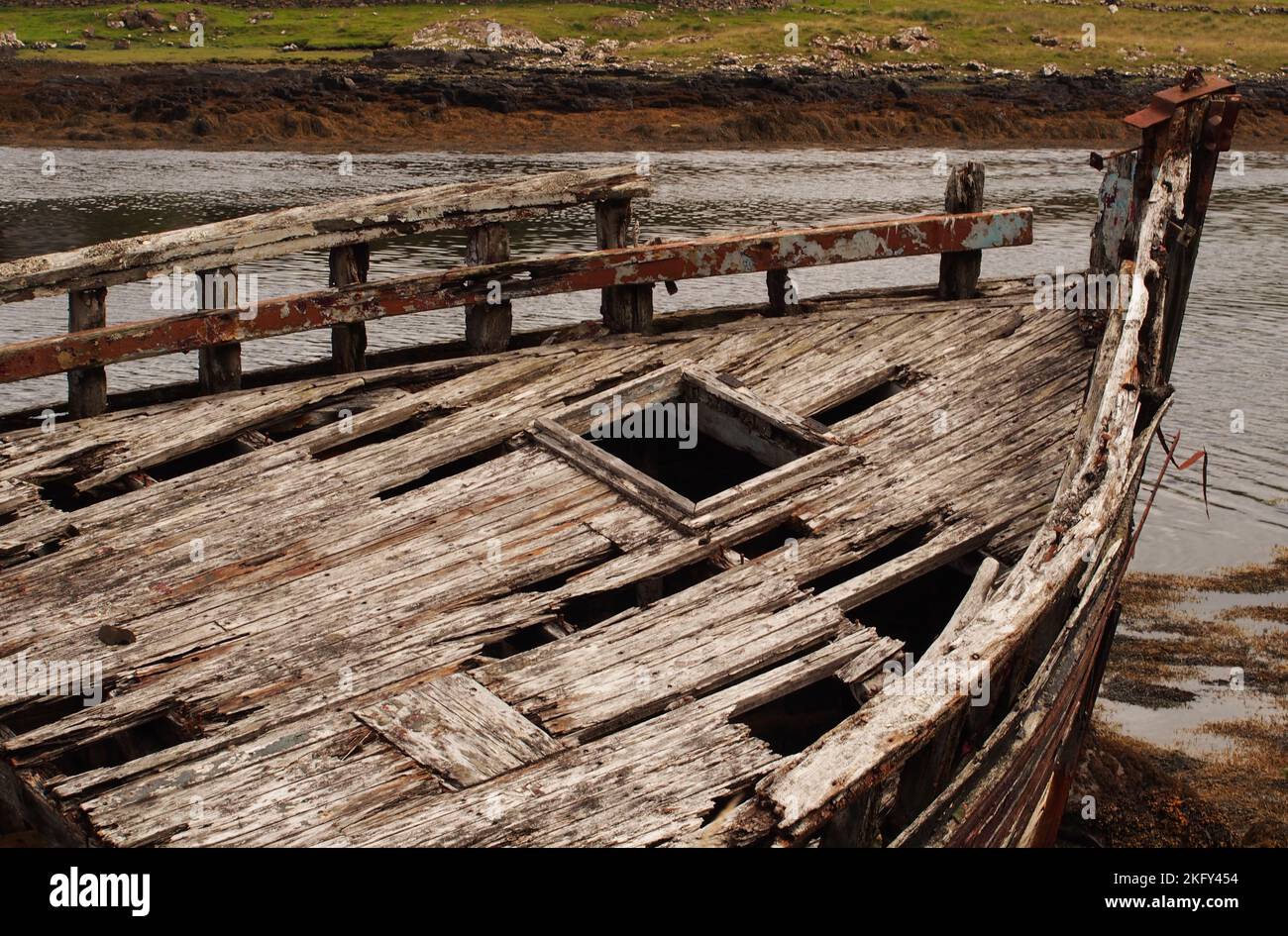 An large, old, wrecked wooden boat, in dry dock, showing the rotting ...