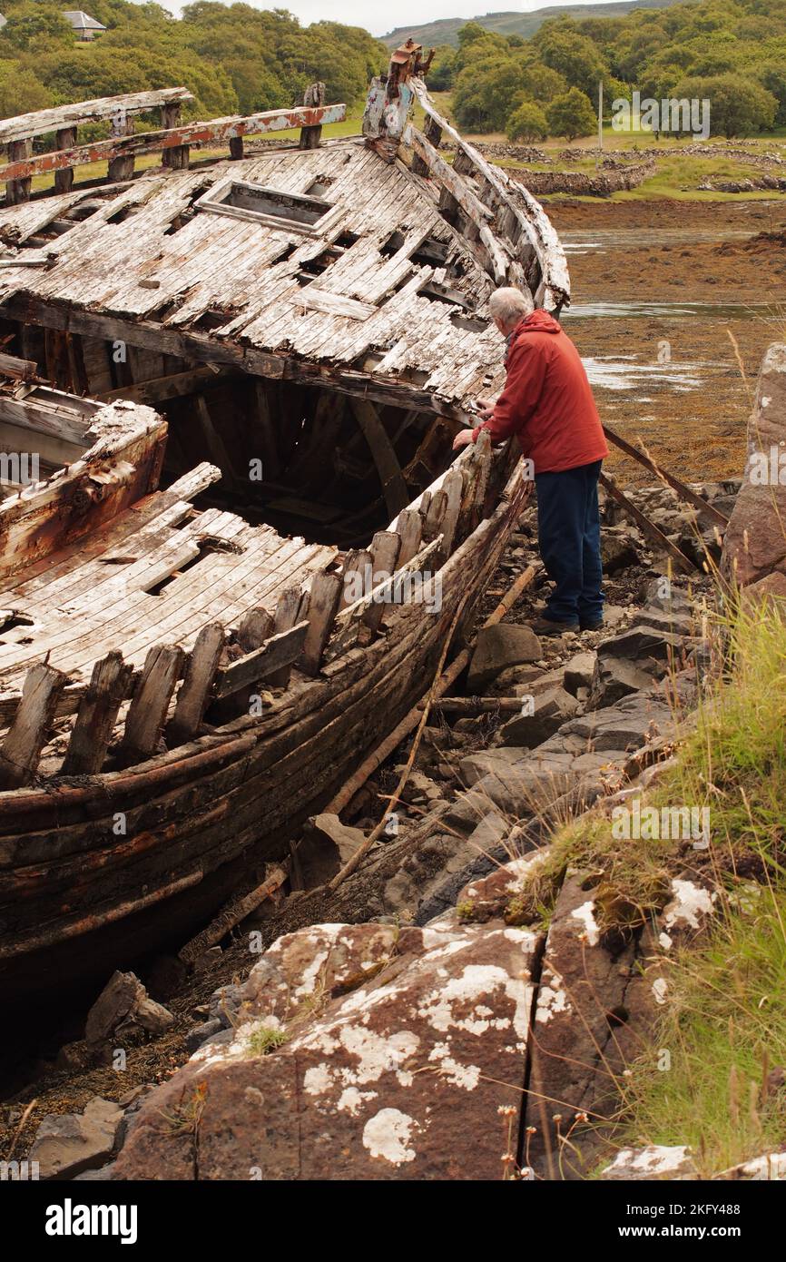 An large, old, wrecked wooden boat, in dry dock, showing the rotting ...