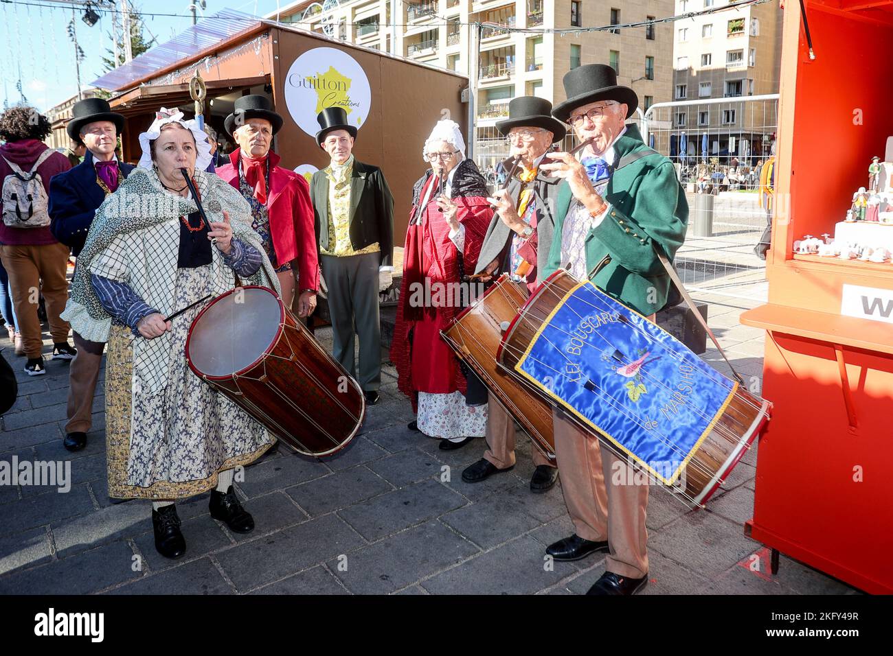 Musicians in traditional Provençal clothes seen in the aisles of the ...