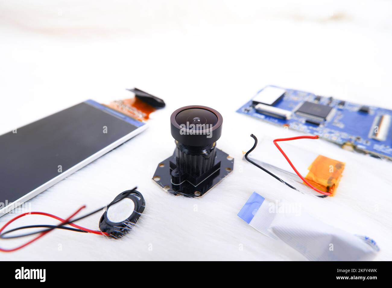 CCTV camera lens parts with a electronics component on white rug floor ...