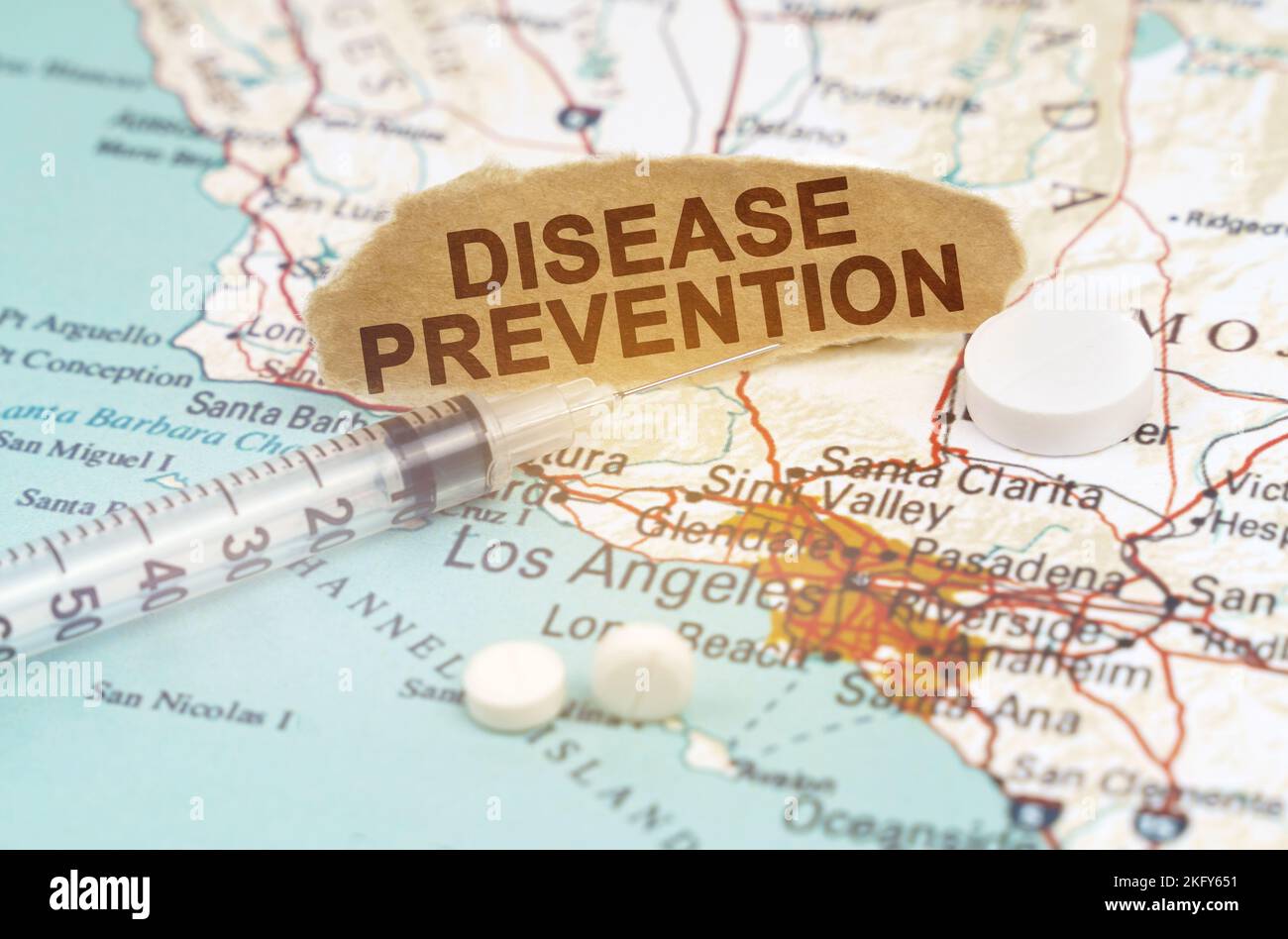 Medicine and health concept. On a map of California lies a syringe ...
