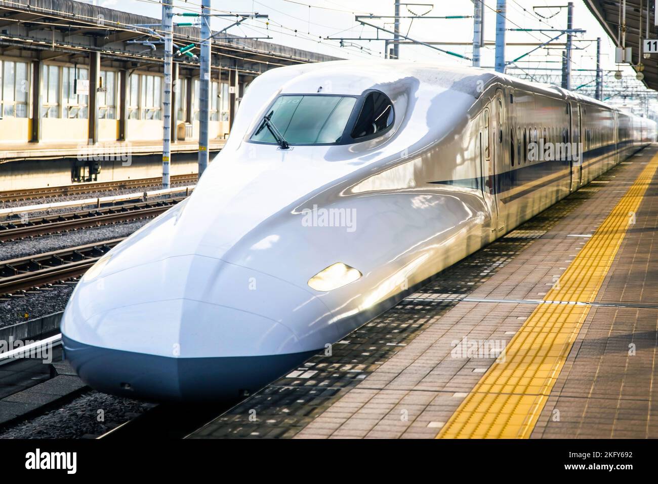 Express white high speed bullet train at track boarding in Japan Stock ...