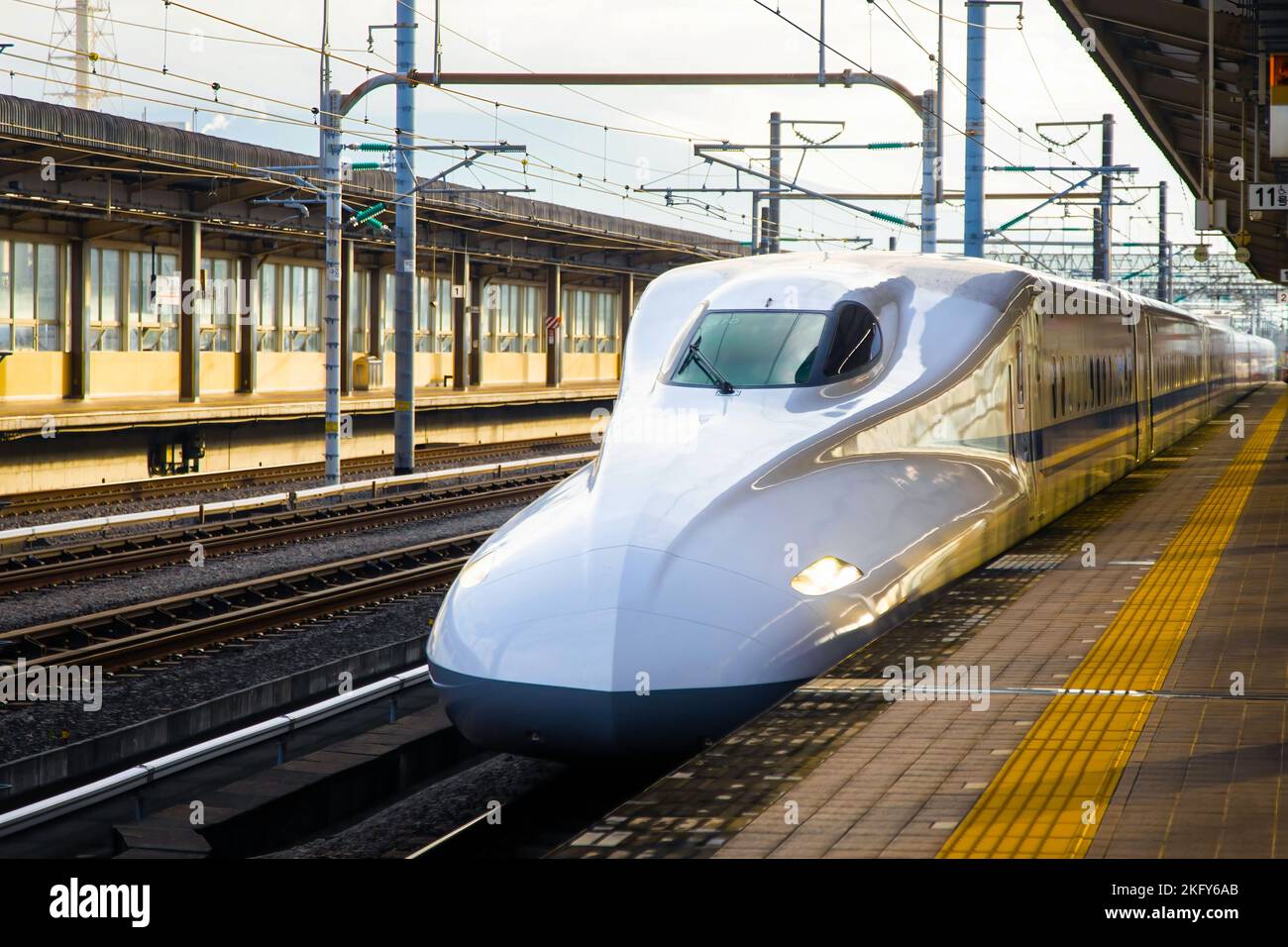 Express white high speed bullet train at track boarding in Japan Stock ...
