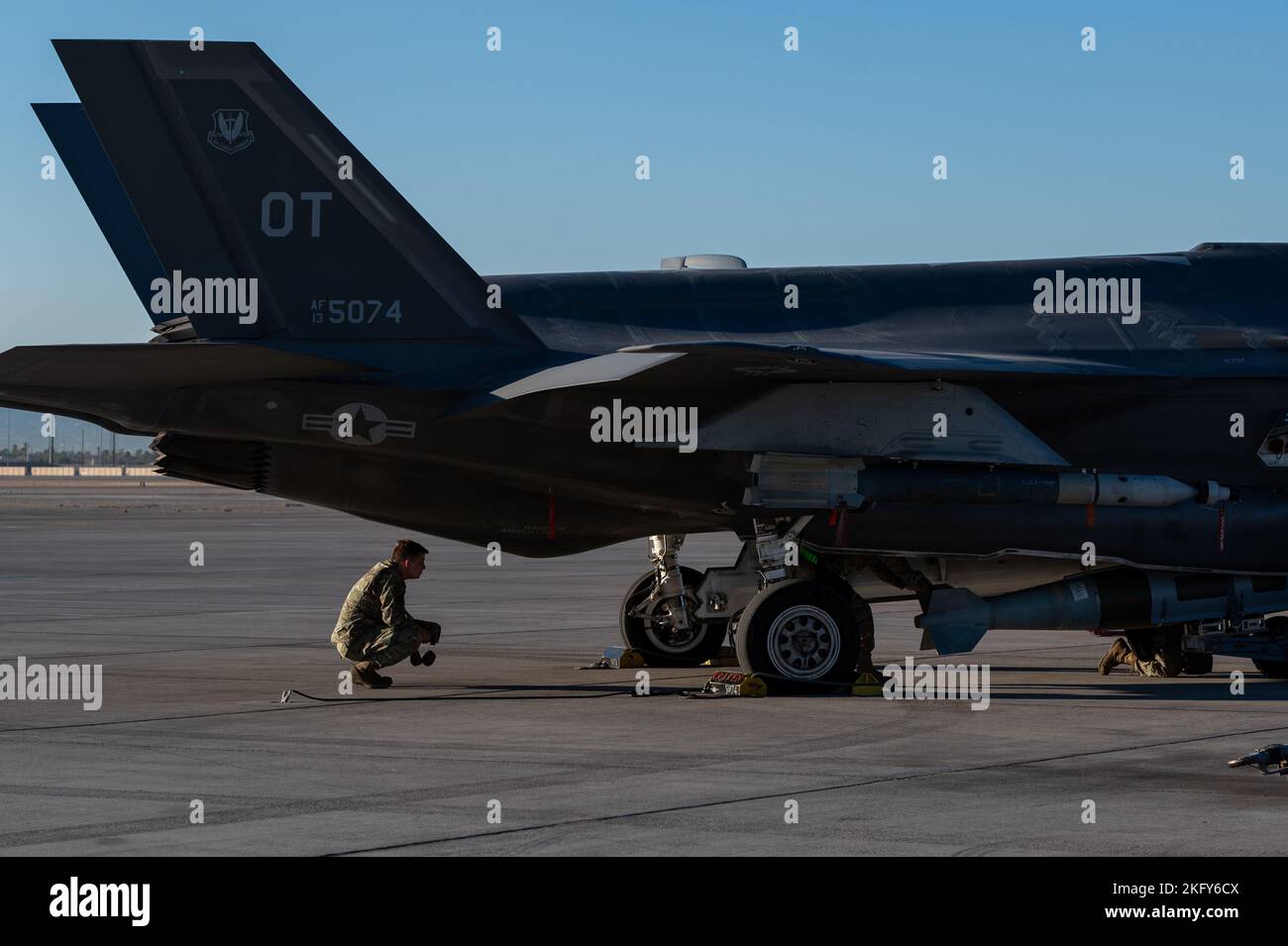 Senior Airman Conner Smith, 57th Maintenance Group Aircraft Armament Systems specialist, guides ...