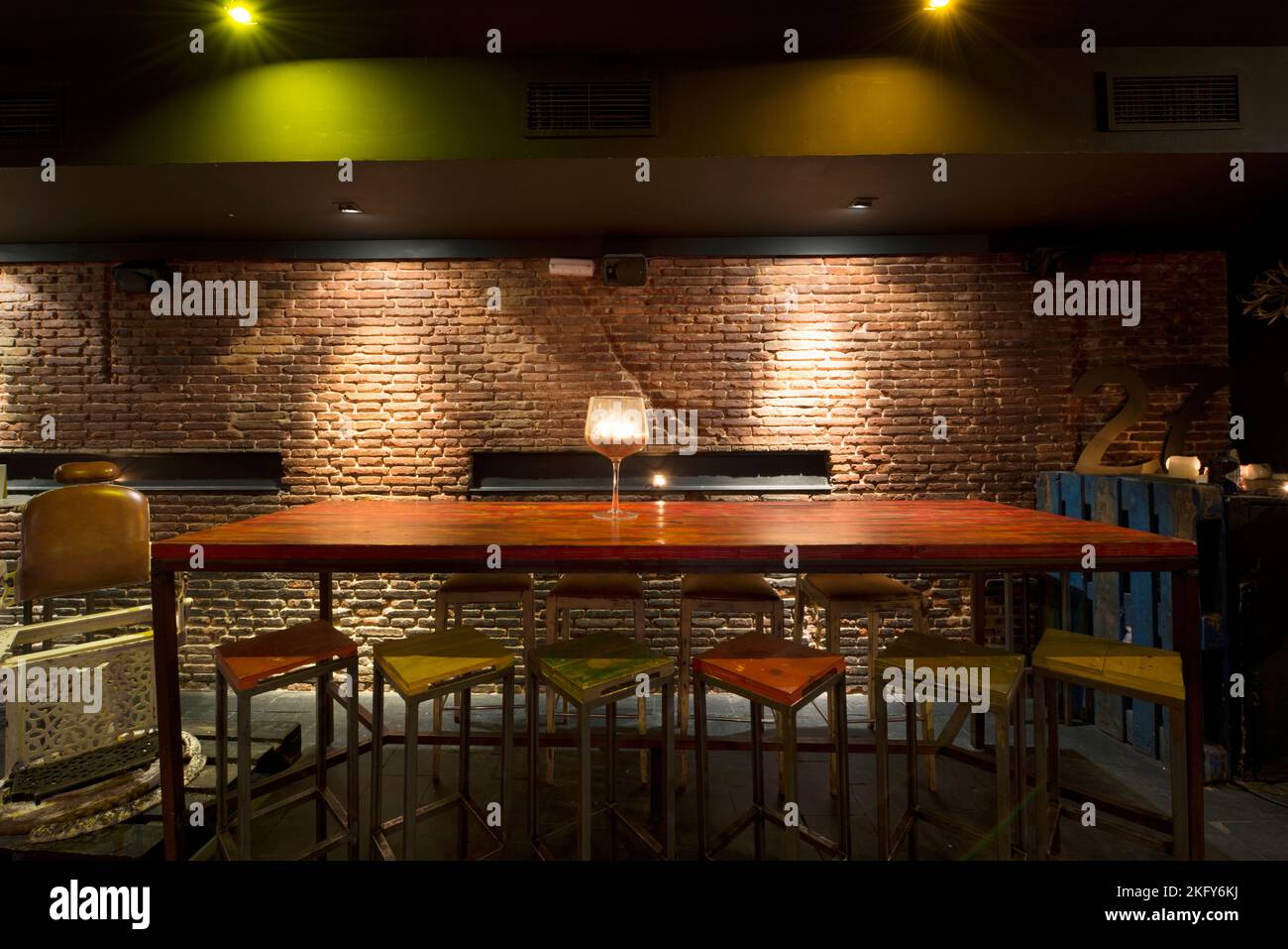 High-top restaurant table with wood and metal, lots of matching stools ...