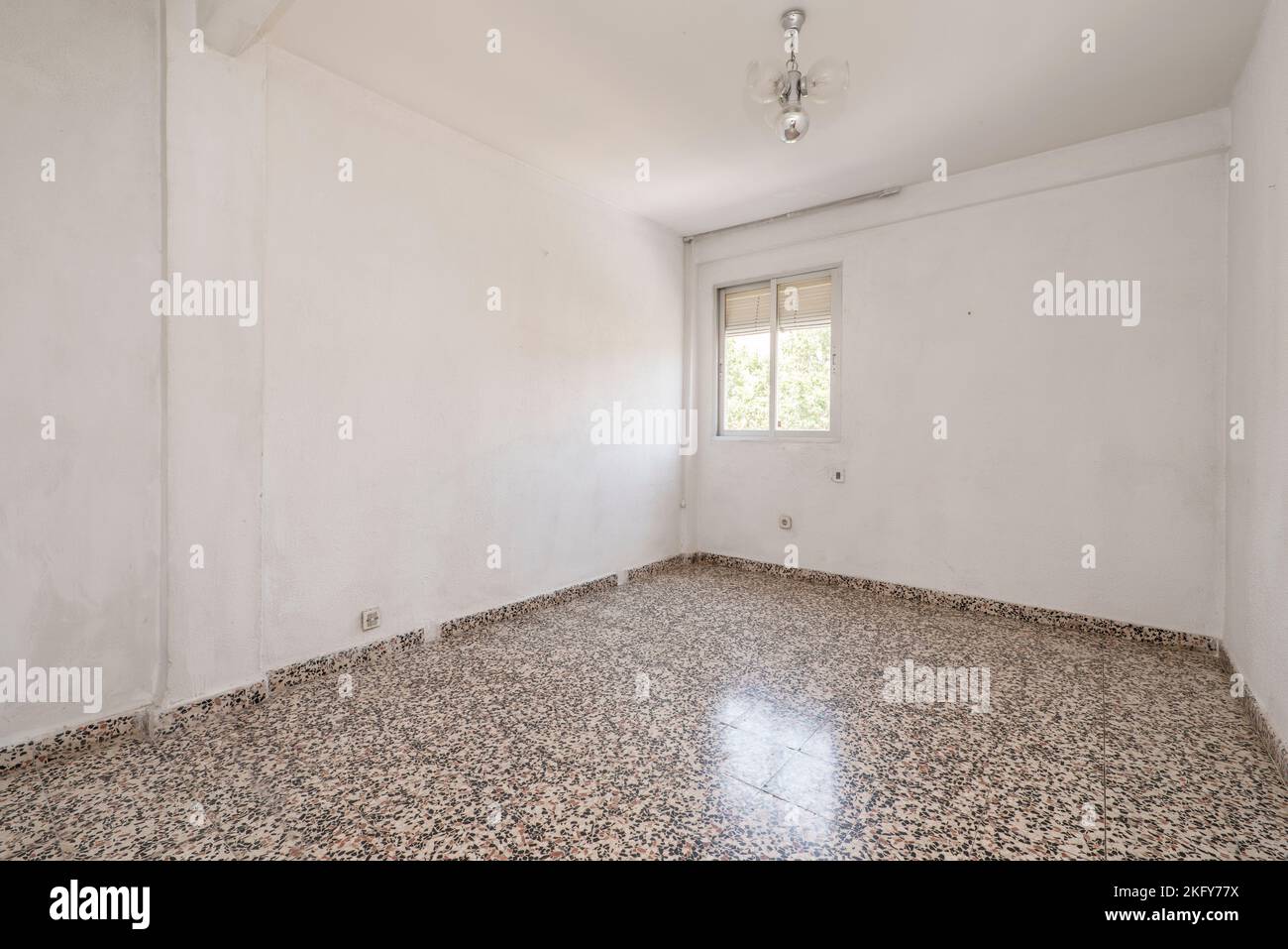 Empty living room with poorly painted white walls, shiny polished ...