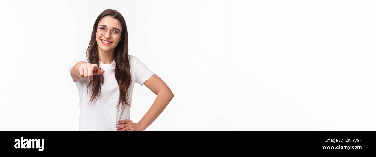 Waist-up portrait of happy smiling young woman inviting you join her ...
