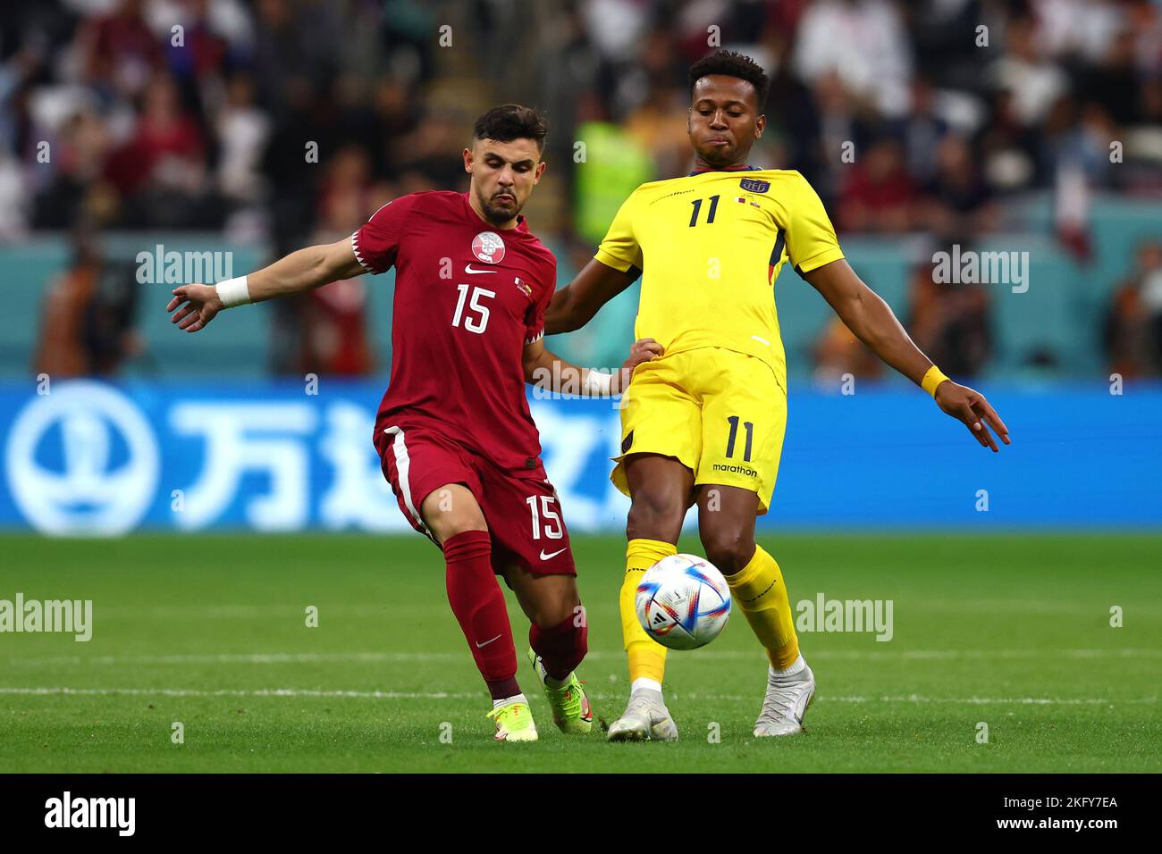 Doha, Qatar. 20th Nov, 2022. Bassam Al-Rawi (L) of Qatar in action with ...