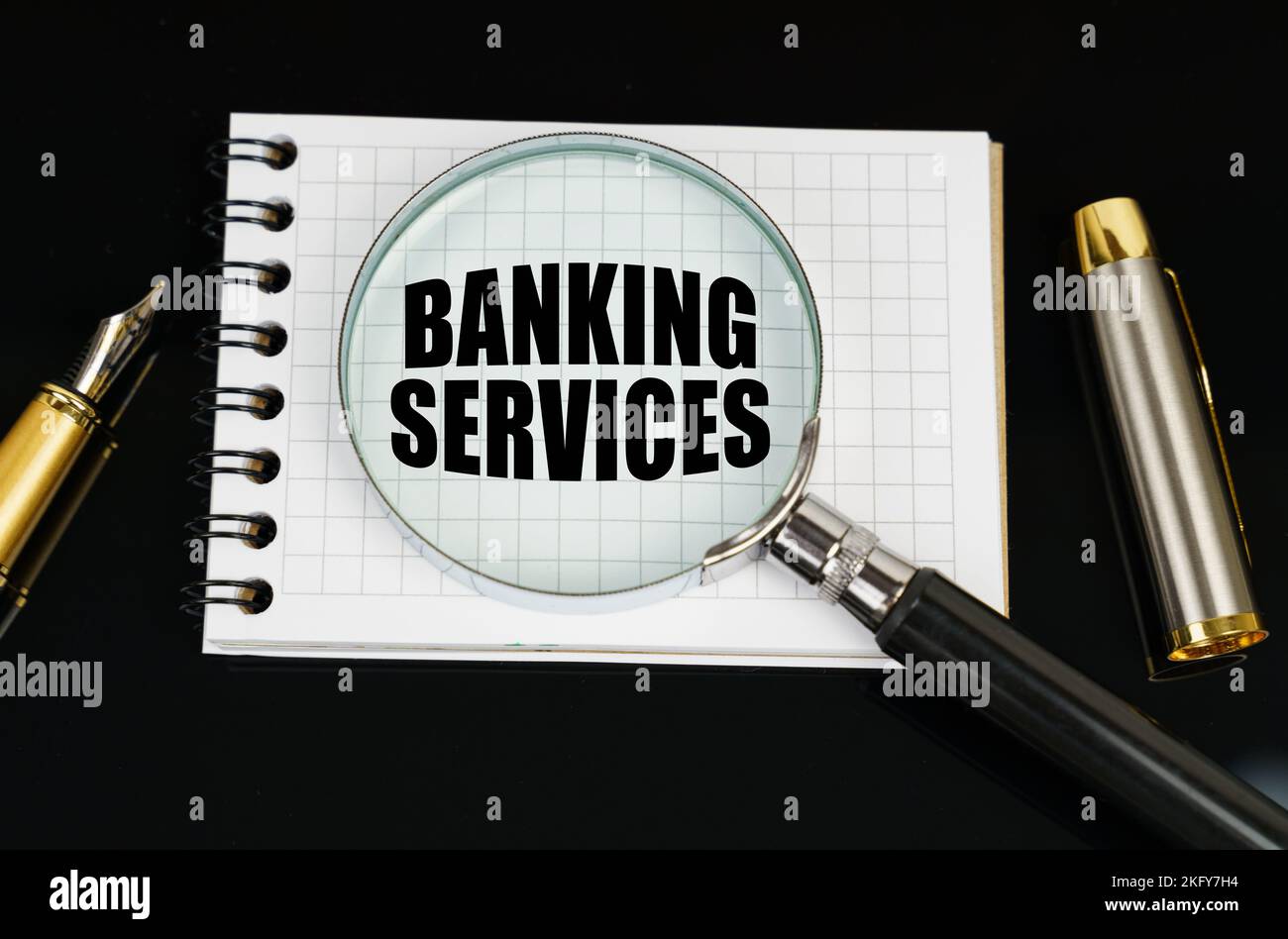 Business and finance concept. On a black surface there is a pen, a ...