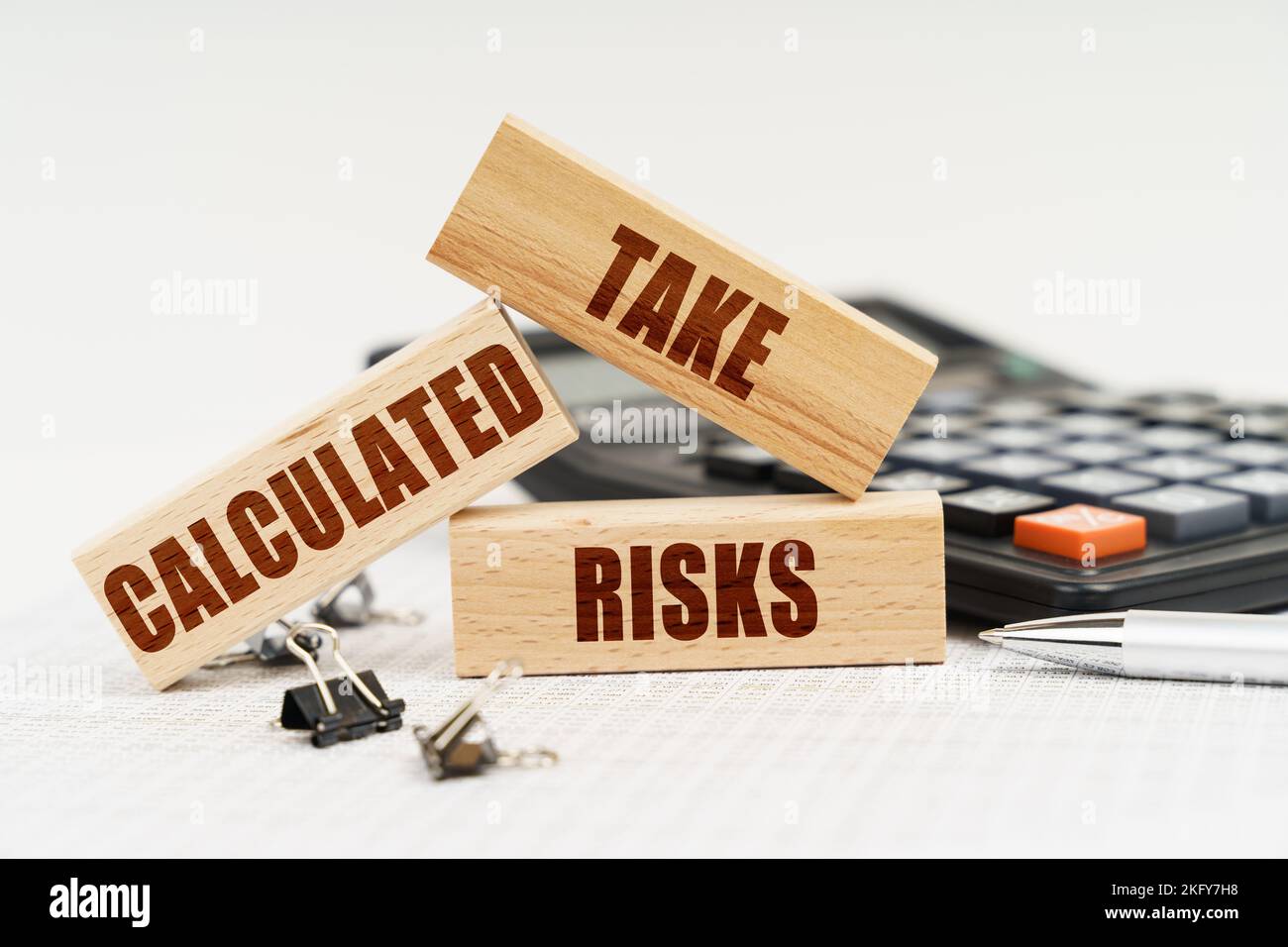 Business and Economics. On the table is a pen, a calculator and small ...