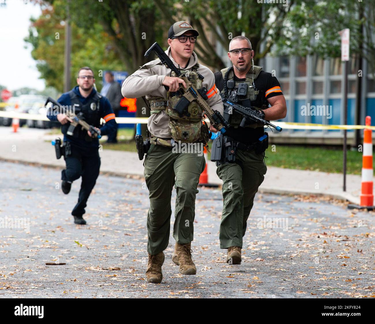 First responders from the local community run toward the main entrance ...