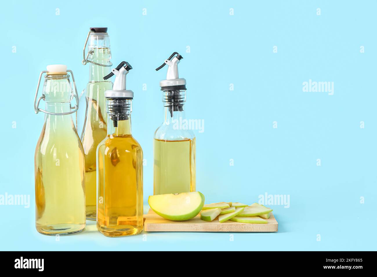 Bottles of apple cider vinegar on color background Stock Photo - Alamy