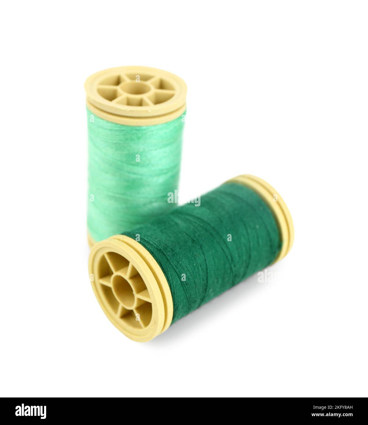 Green thread spools on white background Stock Photo - Alamy