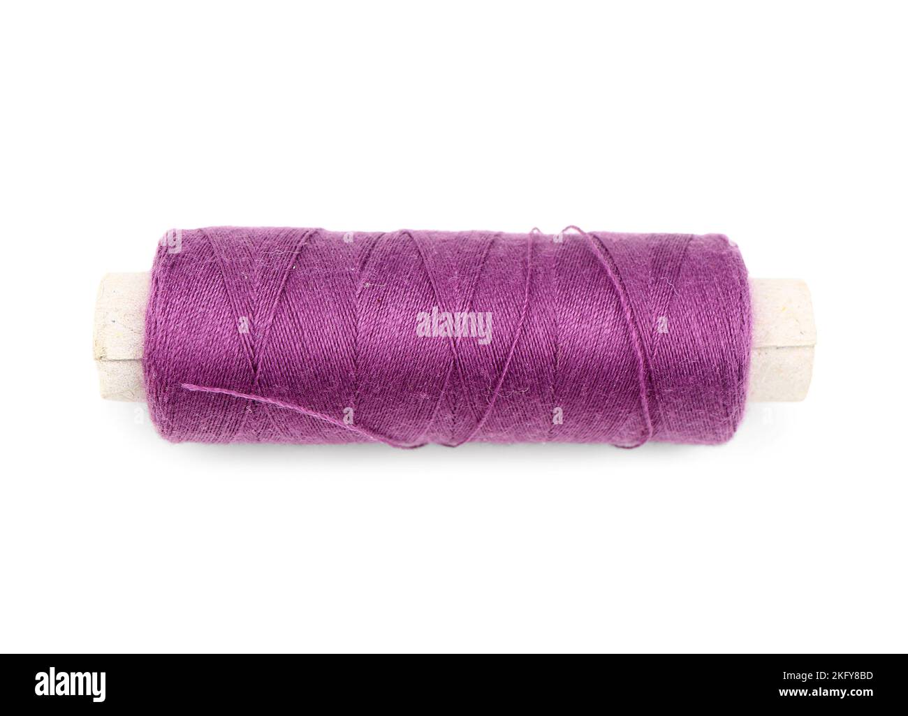Purple thread spool on white background Stock Photo - Alamy