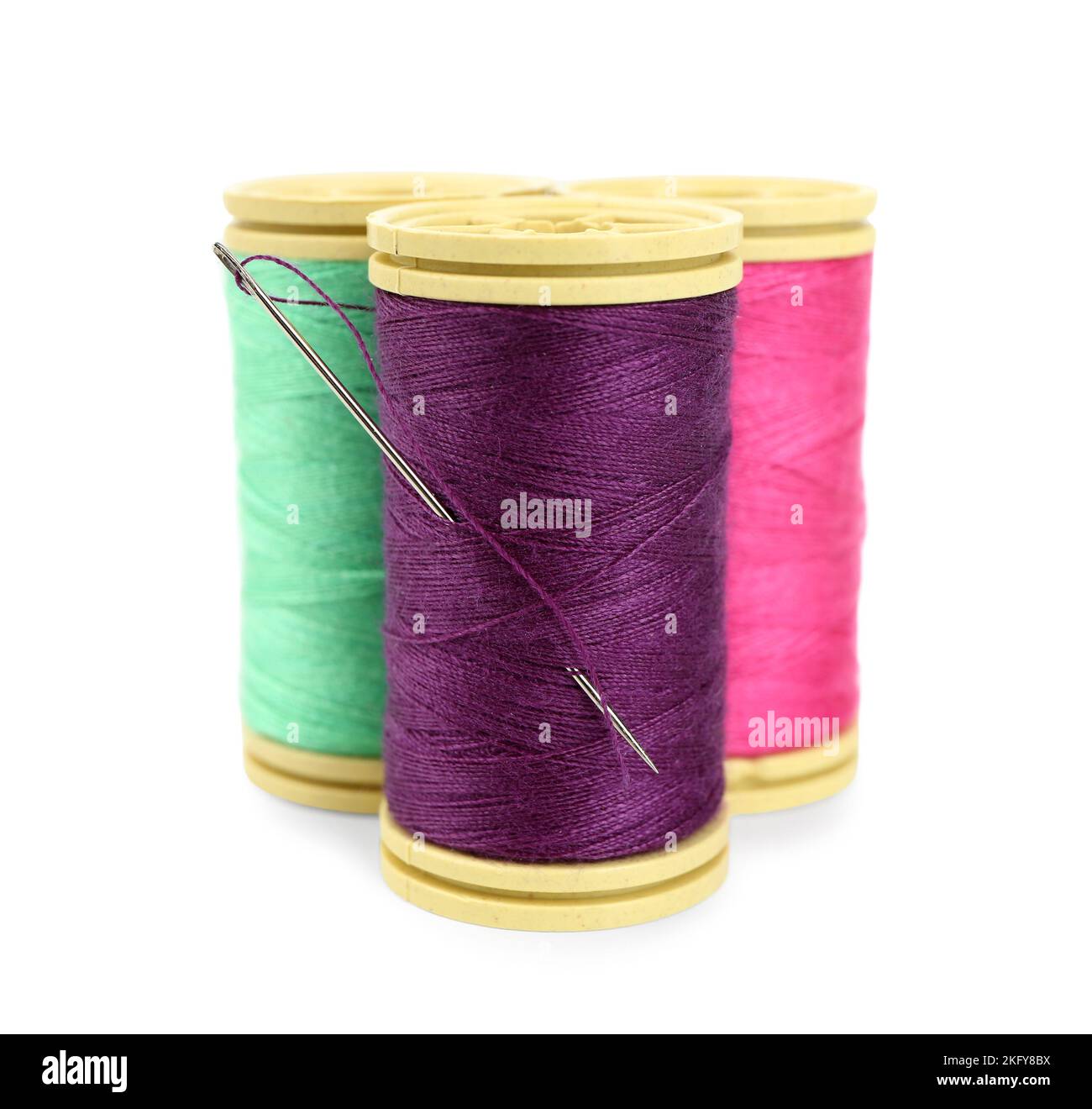 Sewing thread spools with needle isolated on white background Stock ...