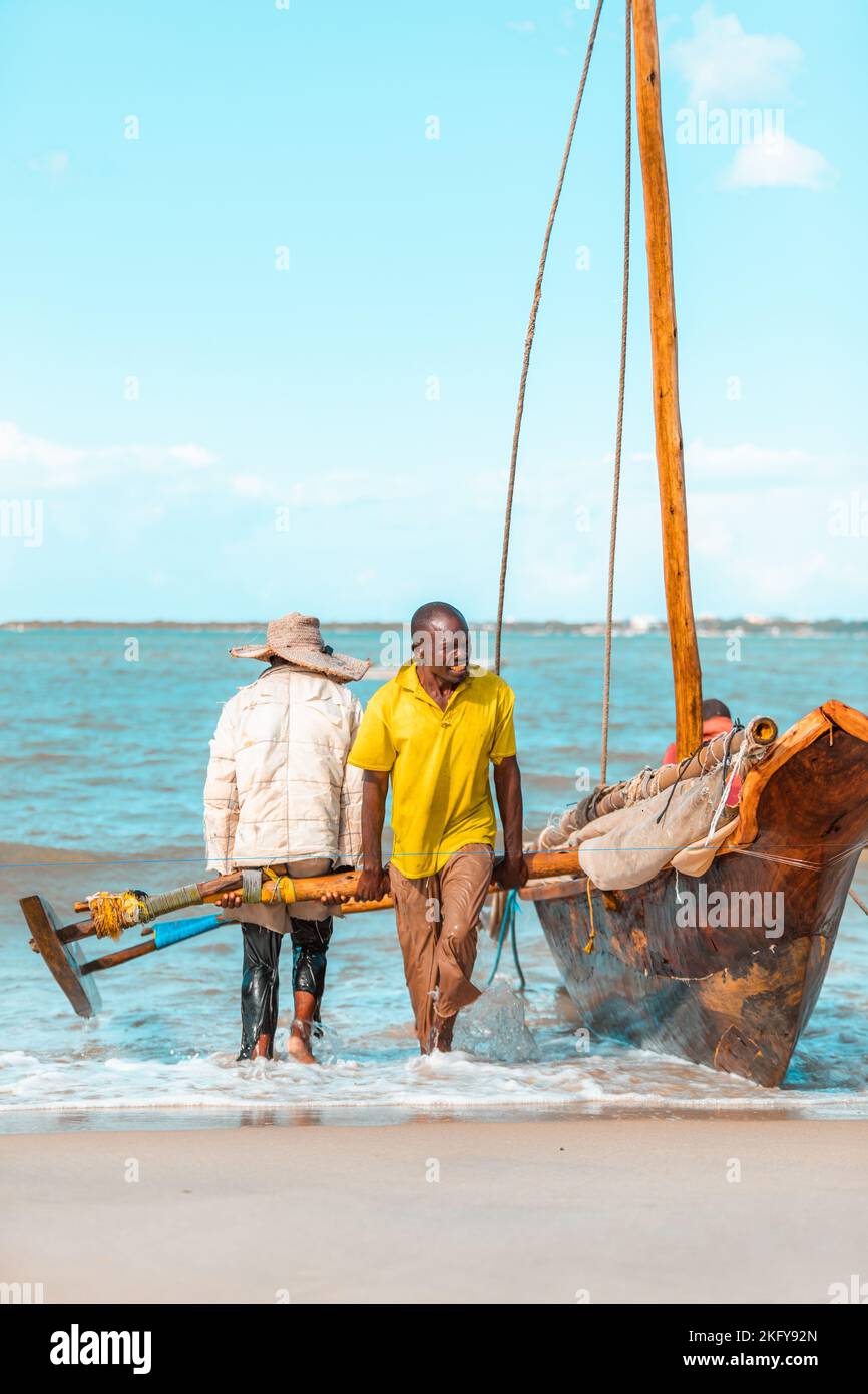 The fishermen pulling the boat out of the water Stock Photo - Alamy