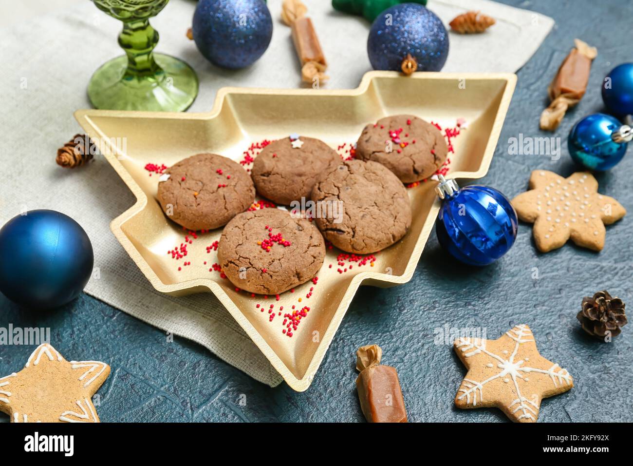 Plate in shape of Christmas tree with treats and decor on dark ...