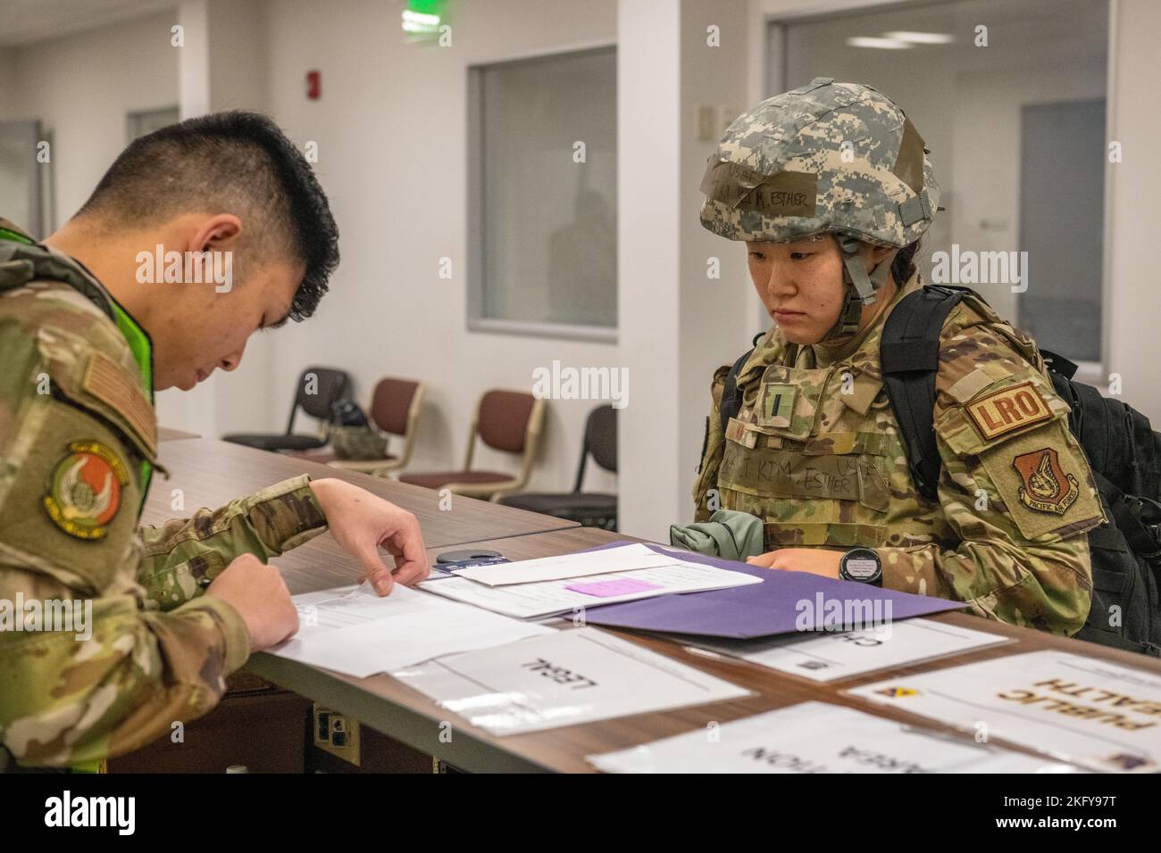 A 374th Logistics Readiness Squadron Airman processes another 374th LRS ...
