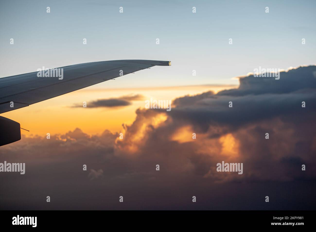 Airplane flight. Aircraft's wing and land seen through the illuminator ...