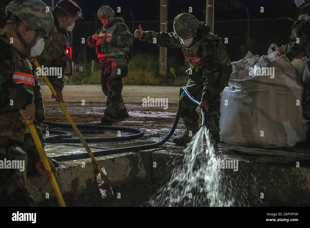 A 374th Civil Engineer Squadron Rapid Airfield Damage Repair team spray ...