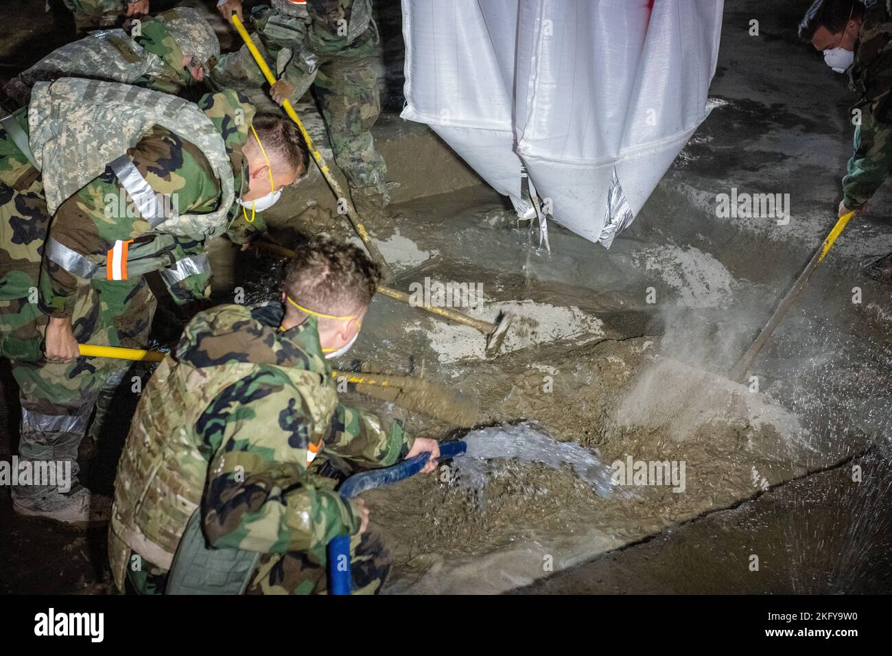 A 374th Civil Engineer Squadron Rapid Airfield Damage Repair team mix ...