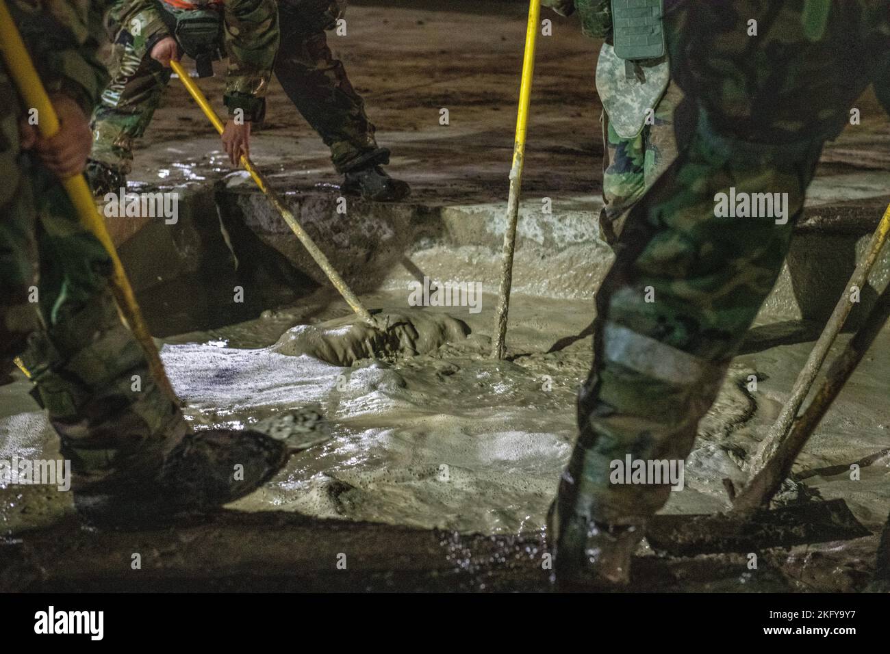 A 374th Civil Engineer Squadron Rapid Airfield Damage Repair team mix ...