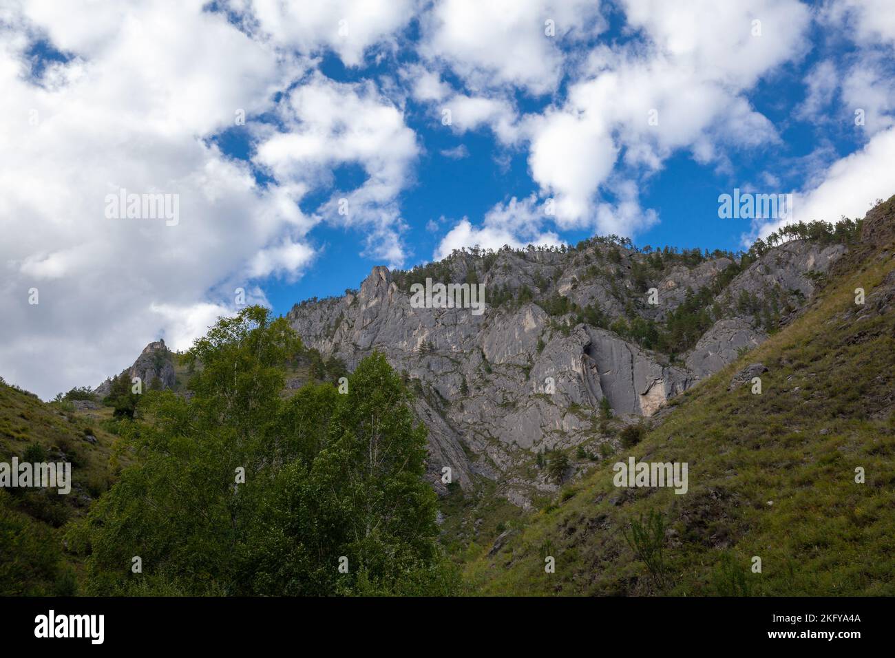 A large mountain with a sheer cliff close-up against the sky Stock ...