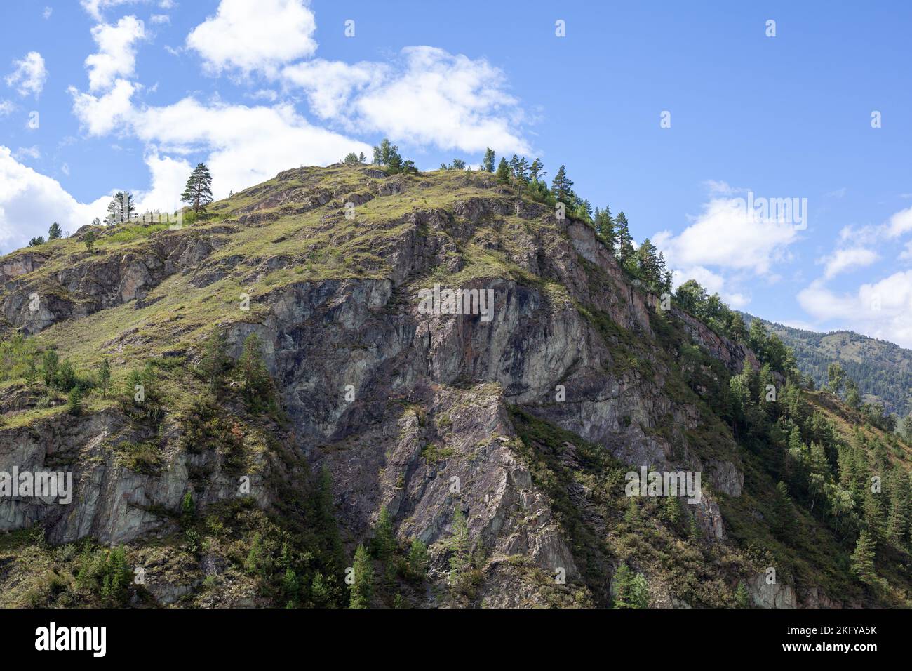 A large mountain with a sheer cliff close-up against the sky Stock ...
