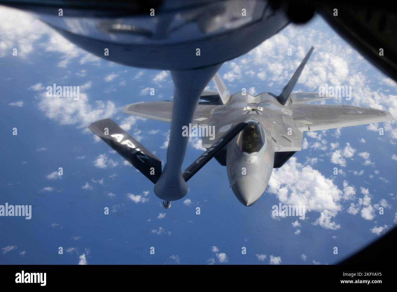 A U.S. Air Force F-22 Fighter pilot maneuvers their jet under a KC-135 ...