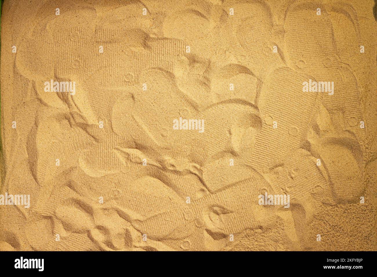 Trampled down sand on the beach with copy space for text. Sand texture ...