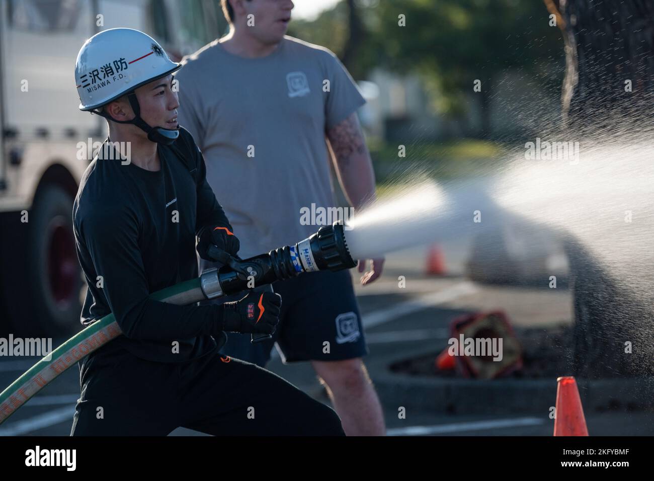 A competitor sprays a fire hose during the annual Fire Prevention Week ...