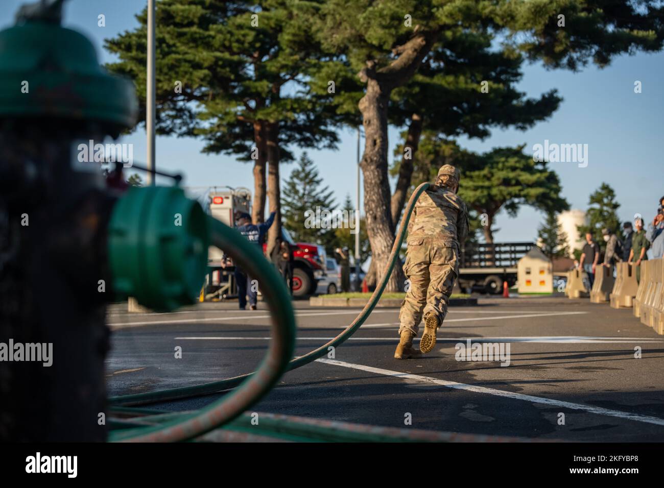 A competitor participates in the fire hose drag during the annual Fire ...