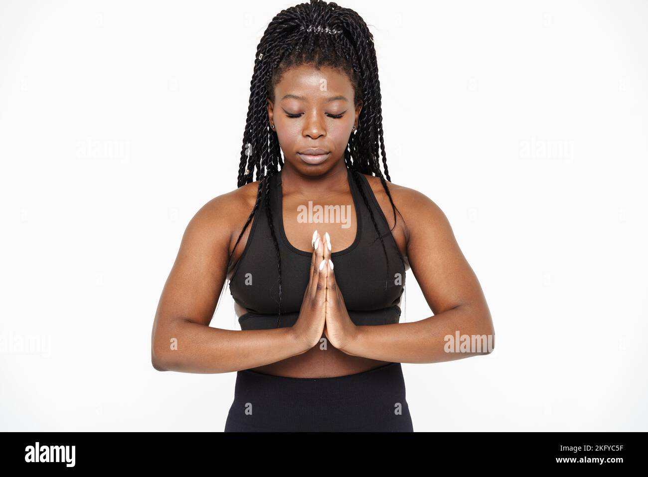 Black young woman standing in pose during yoga practice isolated over ...