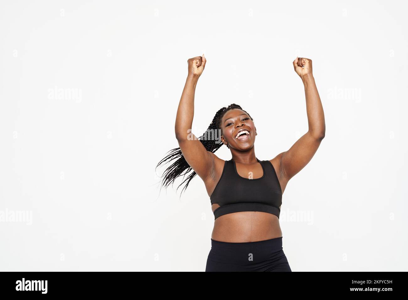 Black young woman screaming while making winner gesture isolated over ...