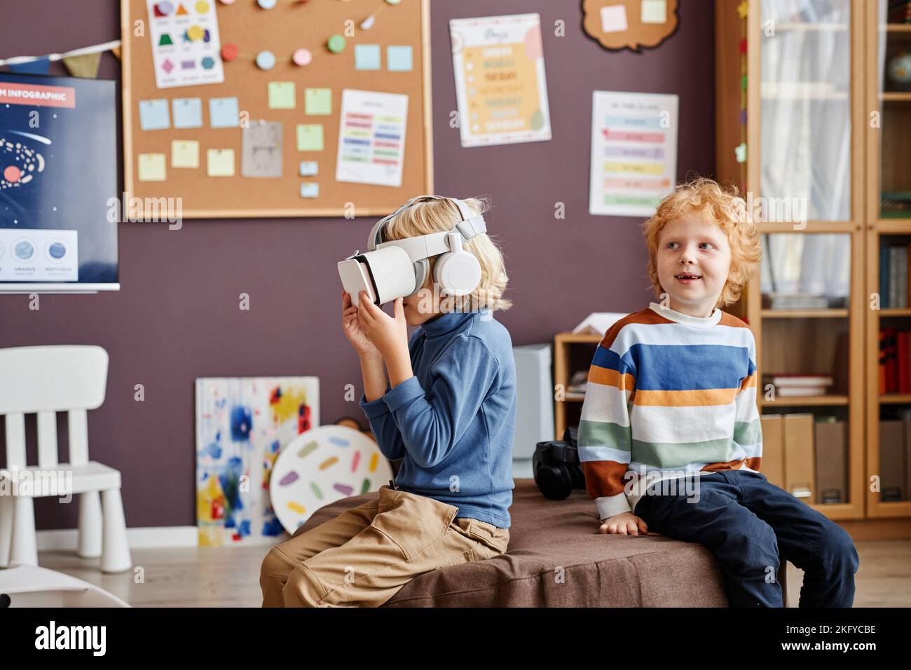 Little boy in vr headset watching video and playing virtual game while ...