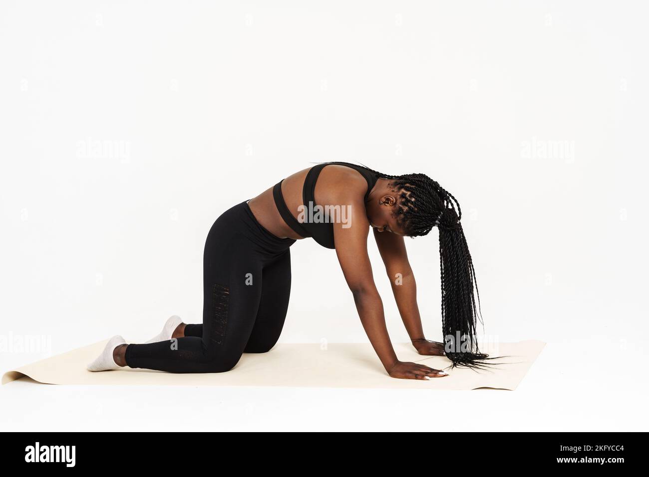 Black young woman standing in pose during yoga practice isolated over ...